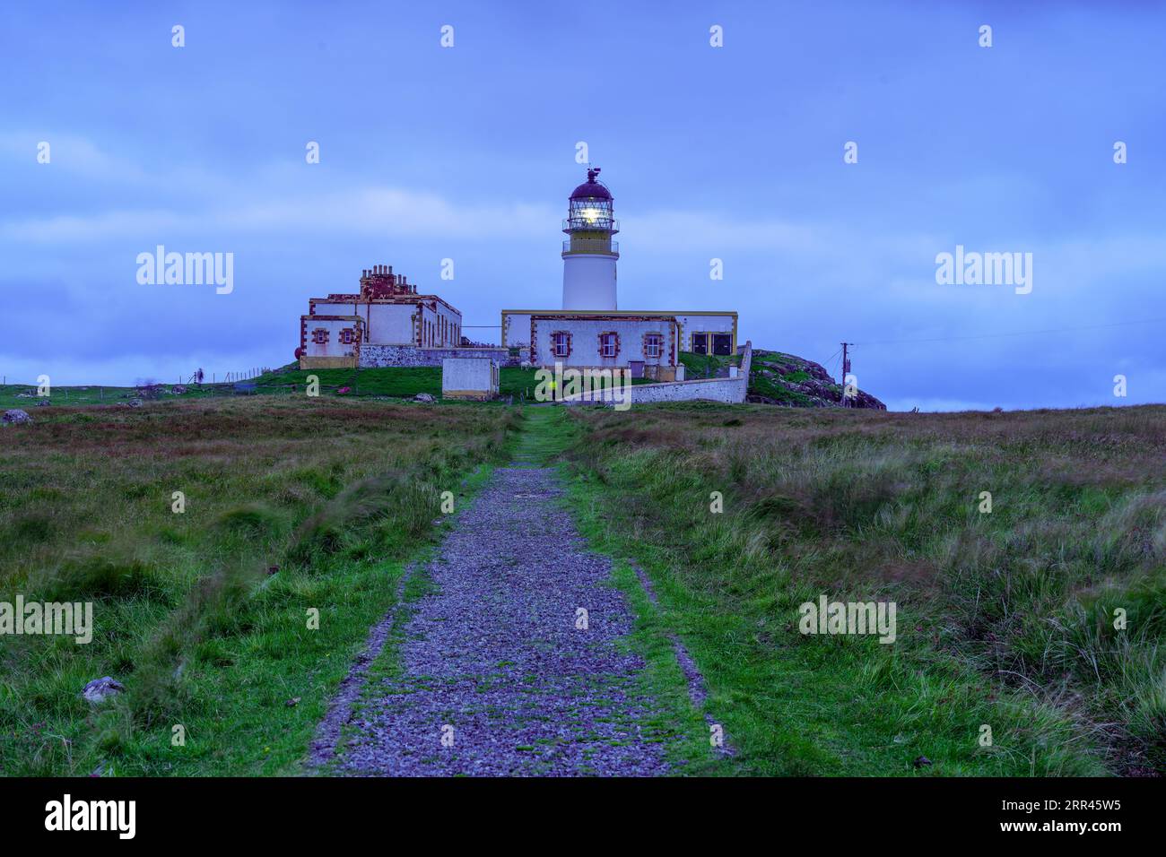 Sunset view of Neist Point Lighthouse, coastal cliffs, and rocks, in ...