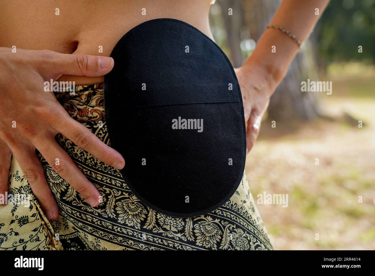 unrecognizable woman with black ostomy bag in the intestine. colon ...