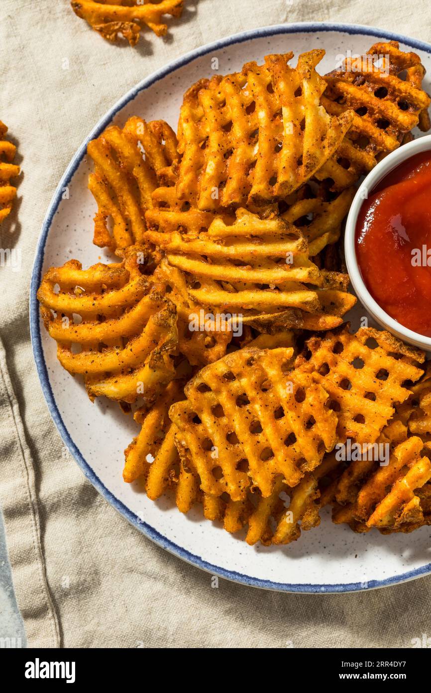 Salty Organic Waffle French Fries with Seasoning and Ketchup Stock ...
