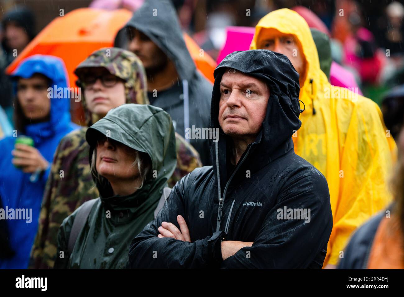 A couple in wets in the main Mountain Stage arena in the rainstorm rain ...