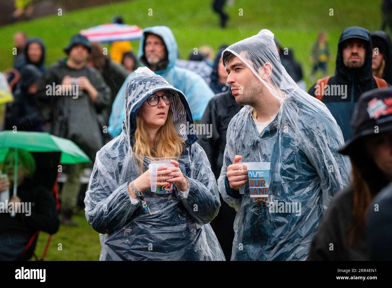 A couple in wets with beers in the main Mountain Stage arena in the ...