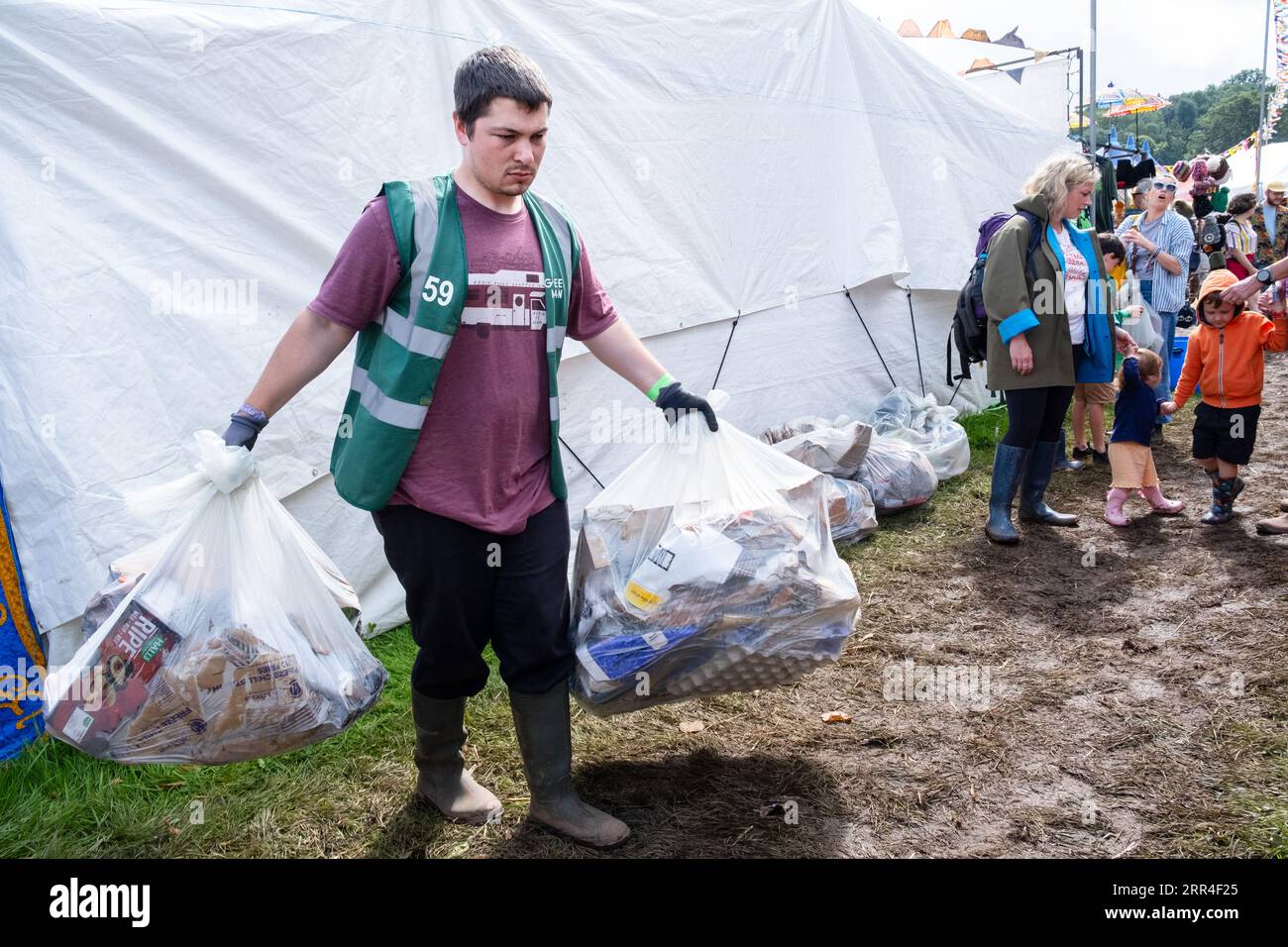 A man collecting trash recycling at Green Man Festival, Brecon, Wales ...