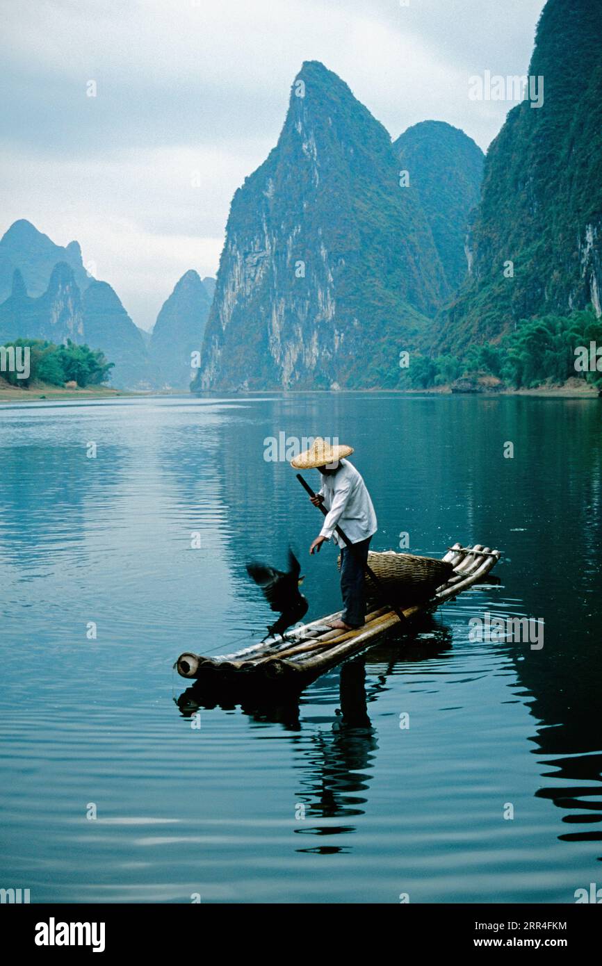 Li River, Guangxi, China: Cormorant fisherman on bamboo raft on river ...