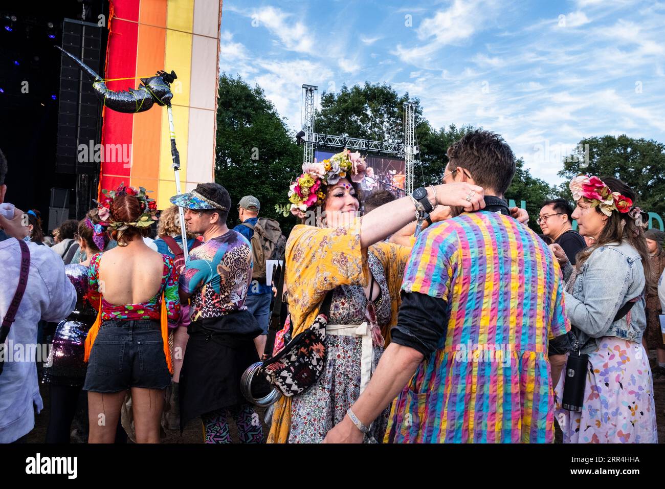 A brightly dressed young couple at the main Mountain Stage at Green Man ...