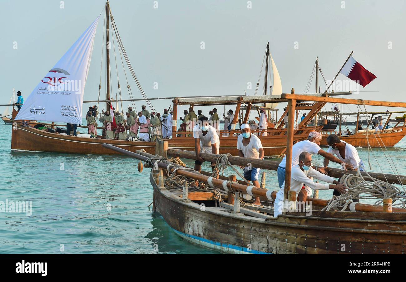 201205 -- DOHA, Dec. 5, 2020 -- People prepare to launch a dhow into ...