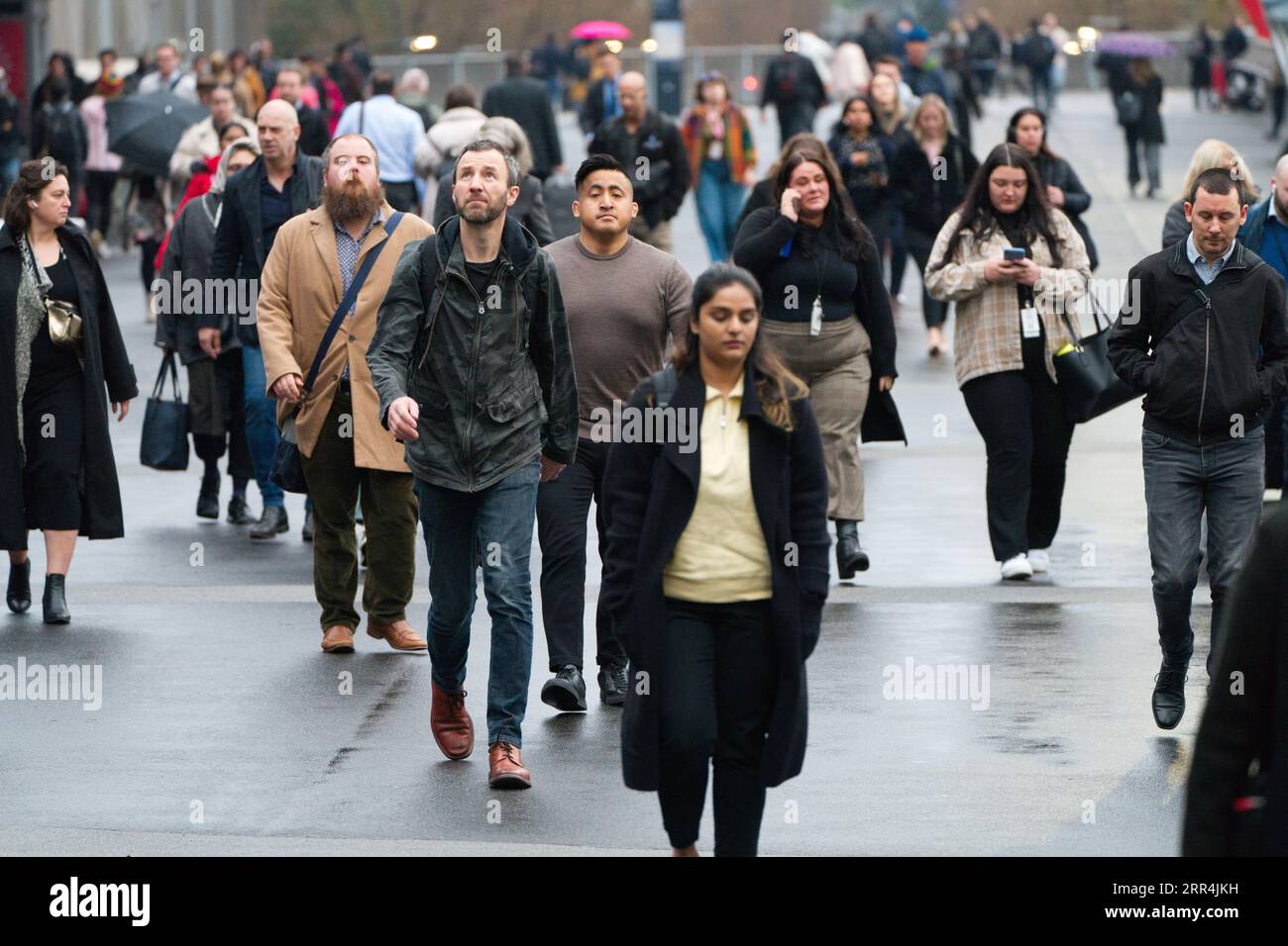 Group of people walking together on a wet day in Melbourne city ...