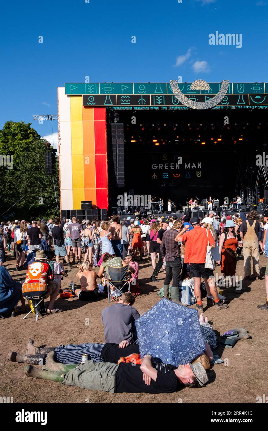 A man takes a quick nap in front of the main Mountain Stage at Green ...