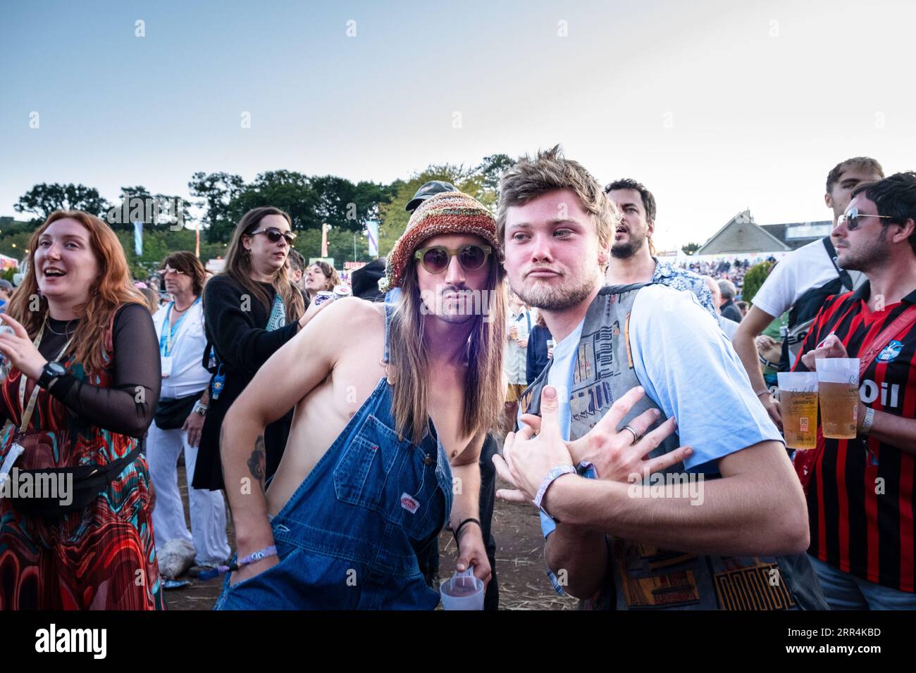 Two funny guys posing in the crowd at sunset at the main Mountain Stage ...