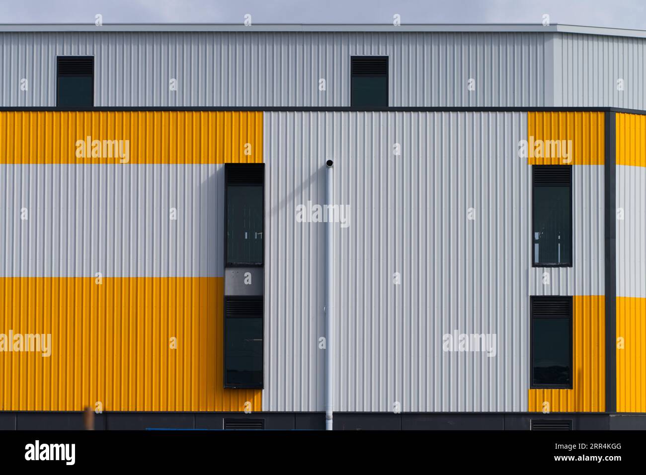 Yellow and grey factory warehouse building exterior abstract side view ...
