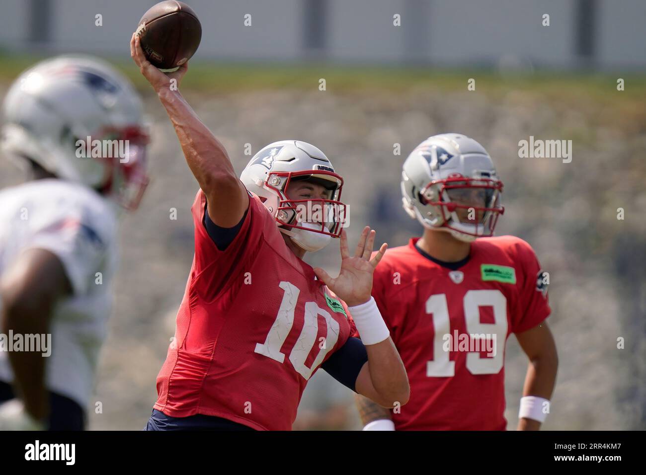 New England Patriots quarterback Mac Jones (10) throws a pass in front of quarterback Matt ...