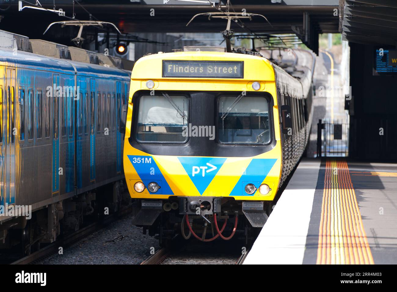 Public transport Melbourne showing an electric passenger train pulling into a suburban train ...