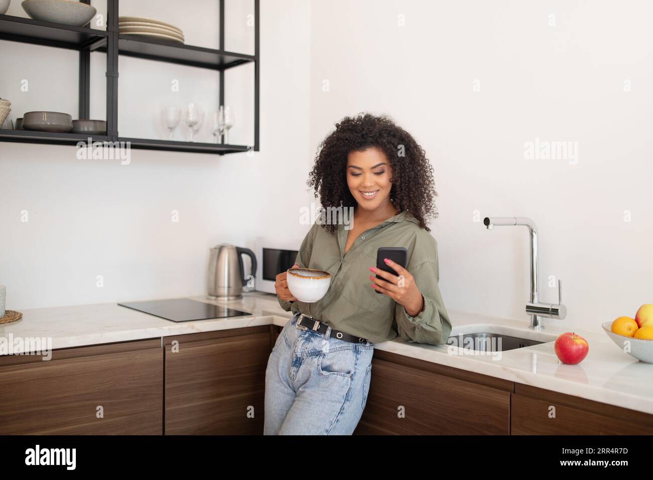 Black Woman Using App On Smartphone At Modern Kitchen Interior Stock ...