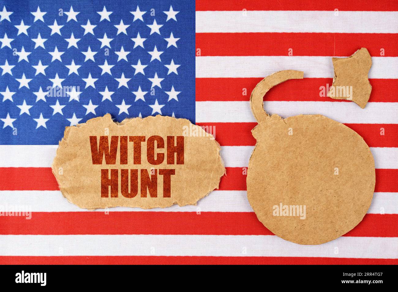 On the flag of the United States are a bomb cut out of cardboard and a ...