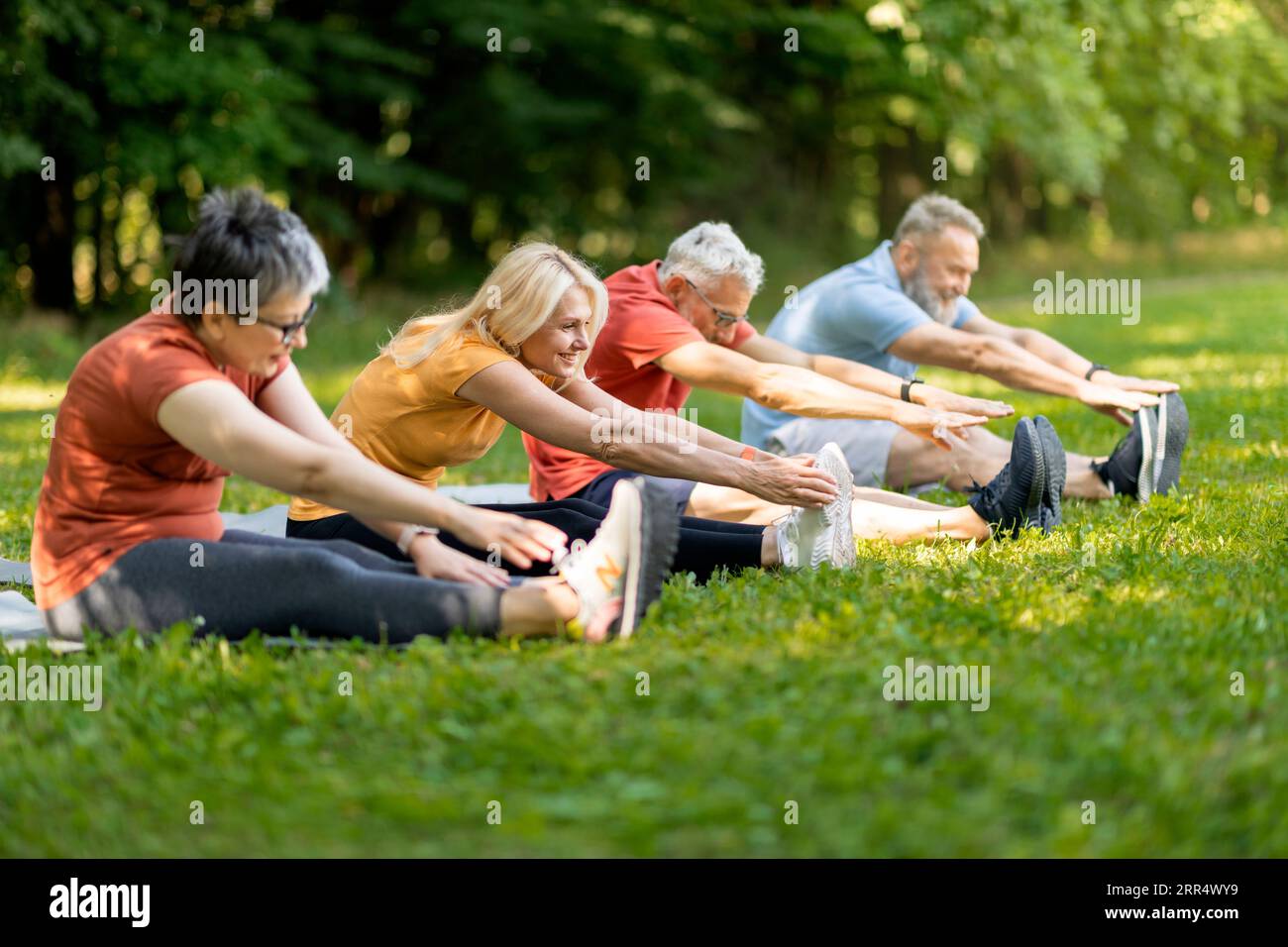 Active Lifestyle. Group Of Sporty Senior People Exercising Together ...