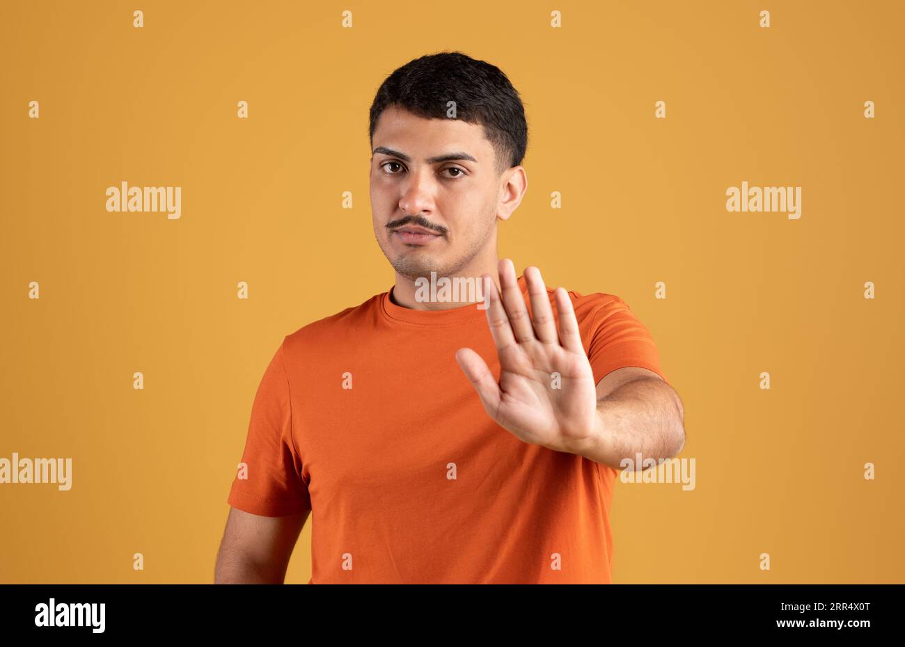 Rejection. Discontented brazilian man gesturing stop with hand ...