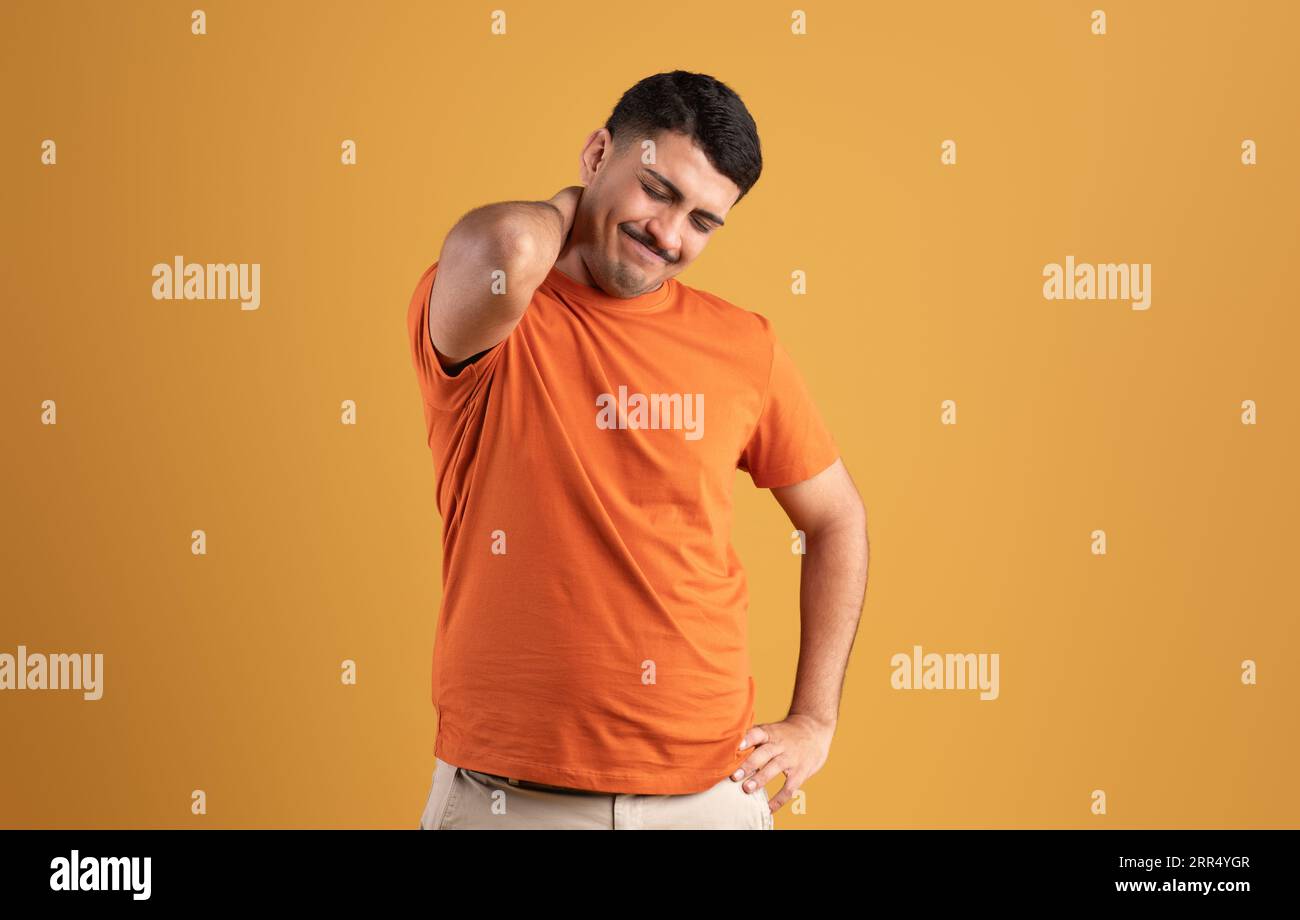 Sad brazilian man in t-shirt pressing his hand to neck and suffering ...