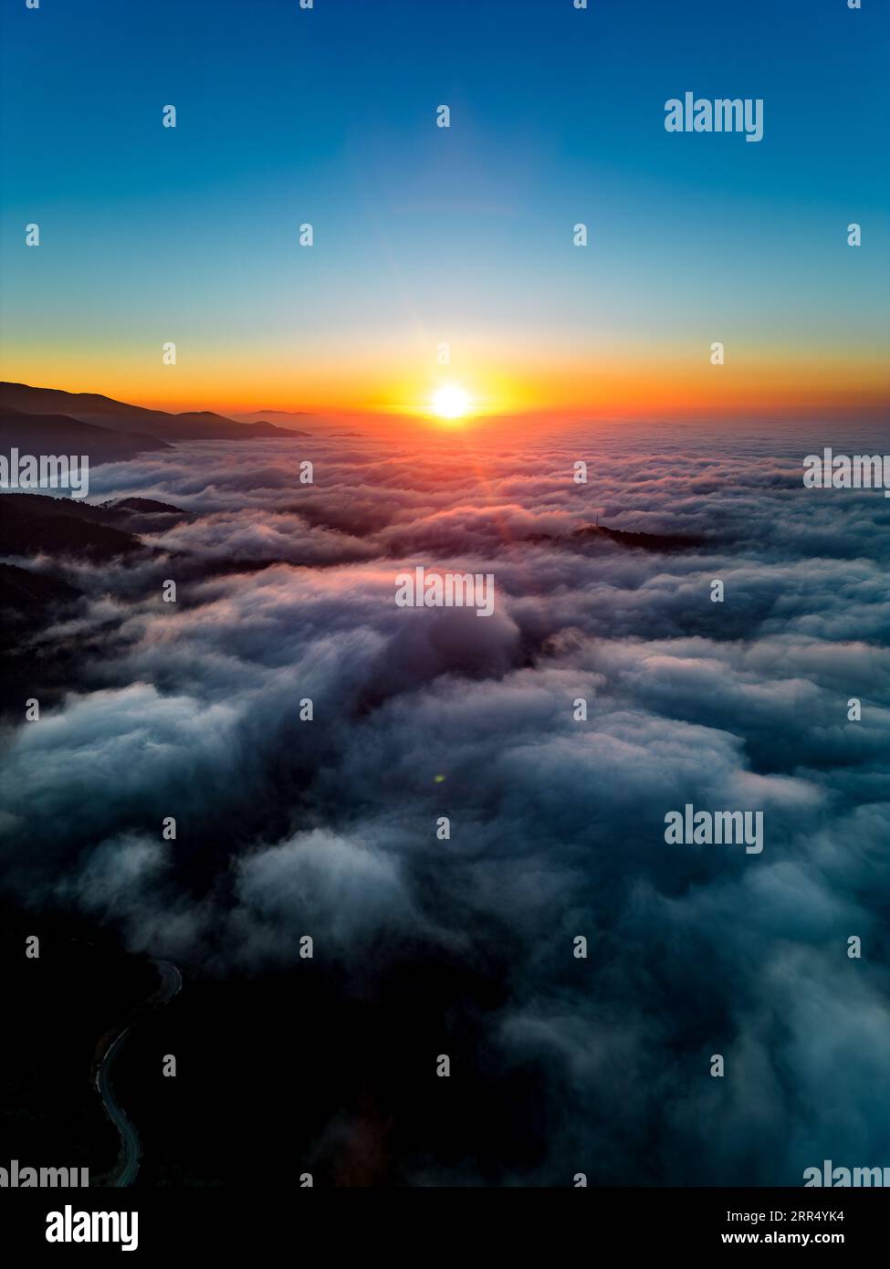 A breathtaking aerial view of a sunset above the clouds, capturing the ...