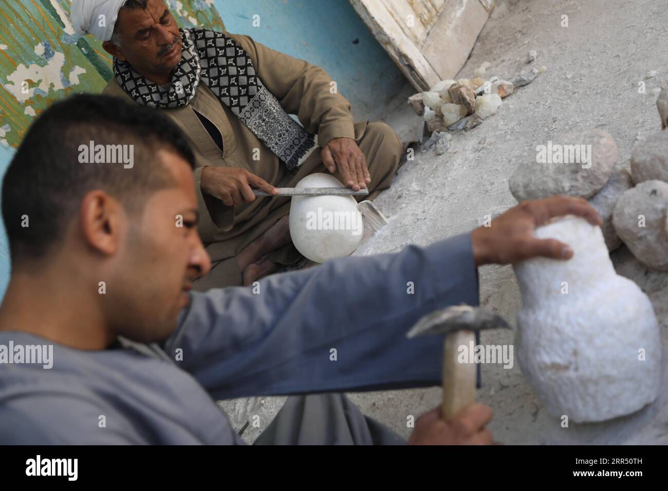 201218 -- LUXOR, Dec. 18, 2020 -- Sculptors work in an alabaster workshop in Gurna Village ...