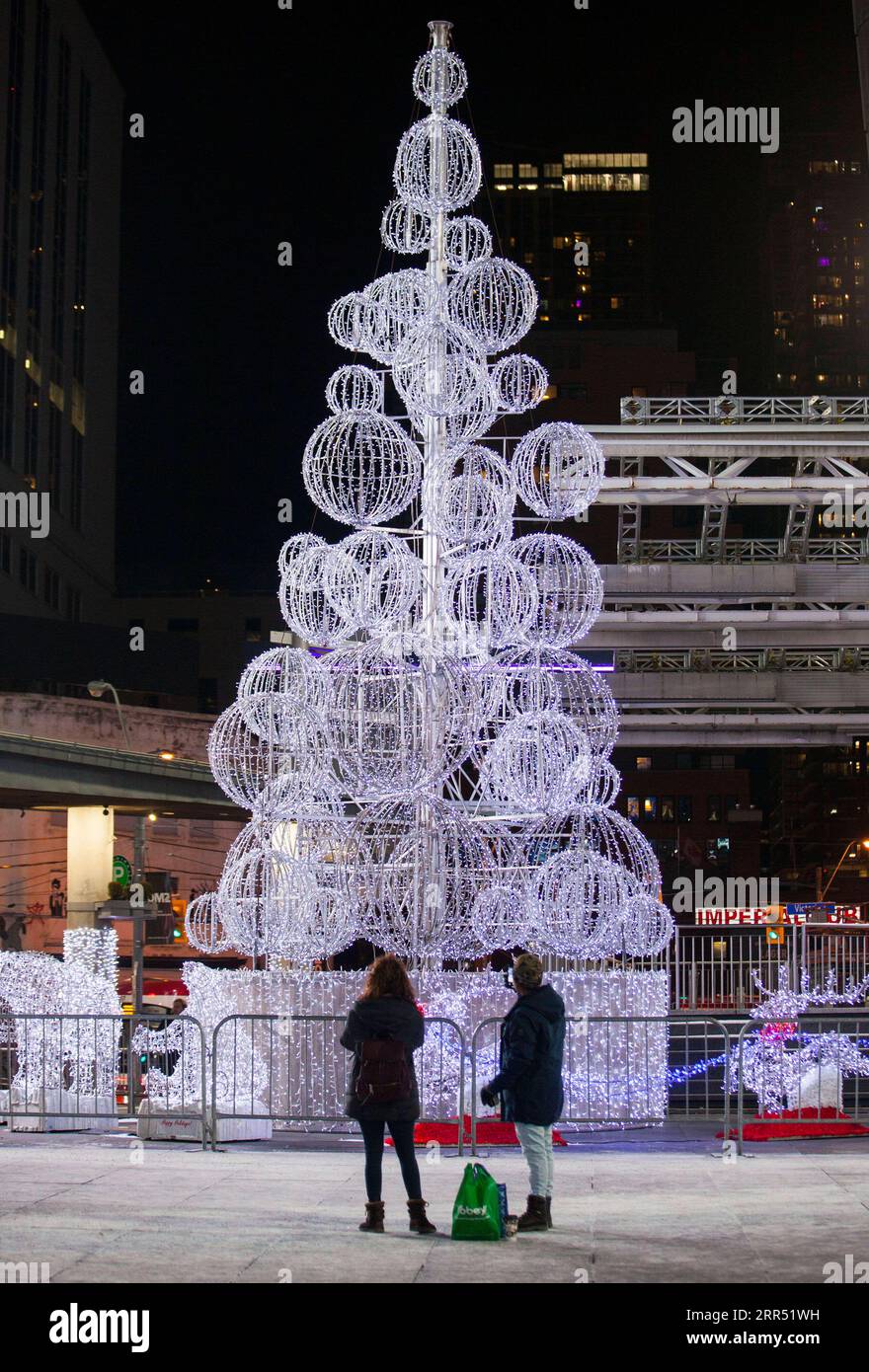 201219 -- TORONTO, Dec. 19, 2020 -- A man takes pictures of a Christmas ...