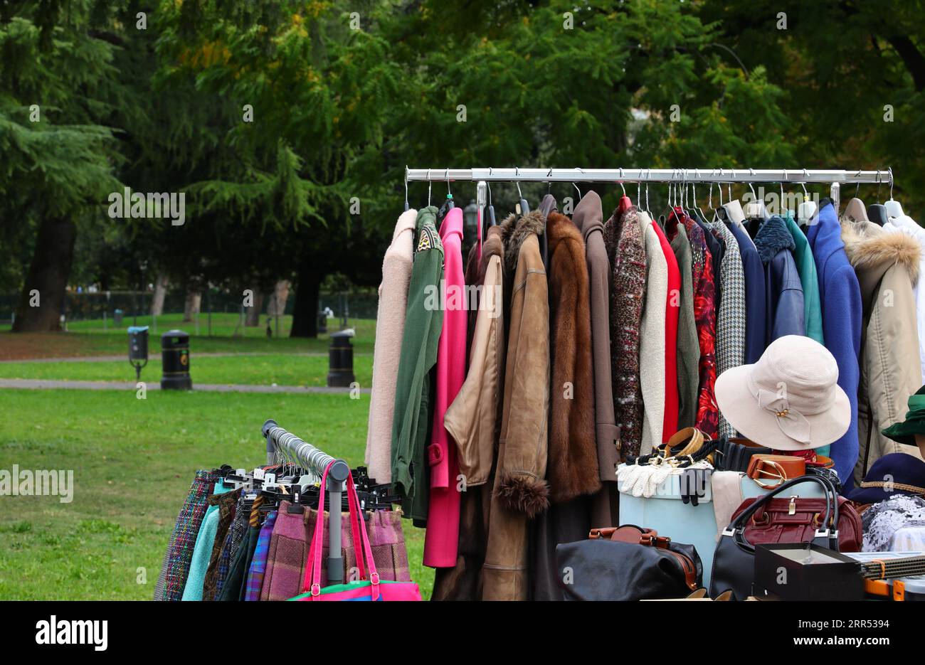 vintage used clothes and new dresses in the stall at the flea market ...