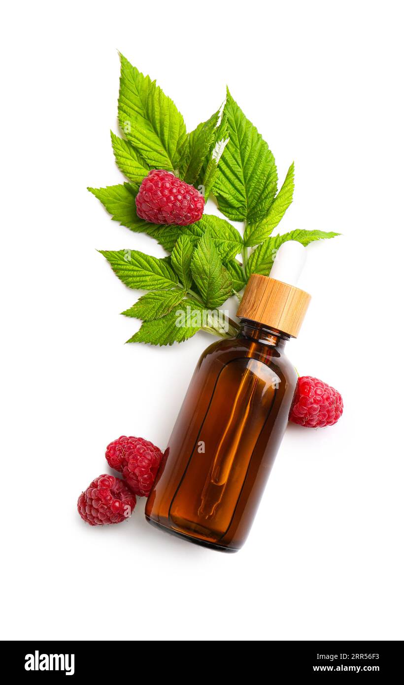 Bottle of cosmetic raspberry oil on white background Stock Photo - Alamy