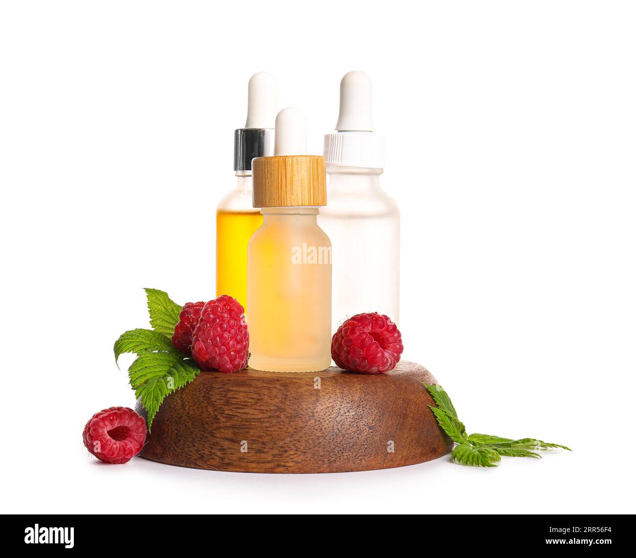 Bottles of cosmetic raspberry oil on white background Stock Photo - Alamy