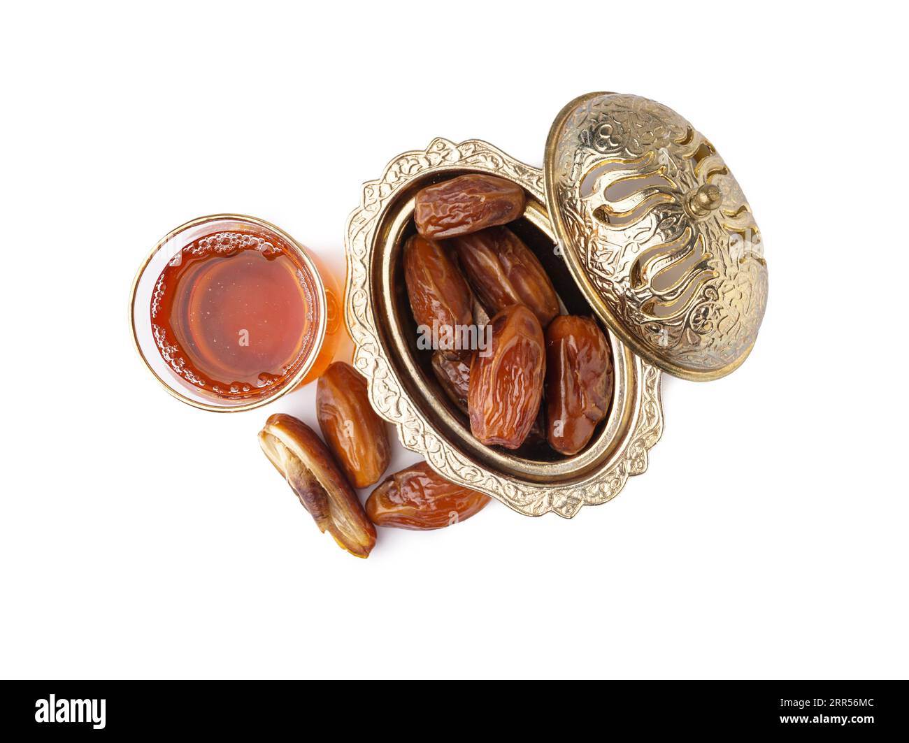 Bowl of dried dates and glass cup with Turkish tea on white background ...