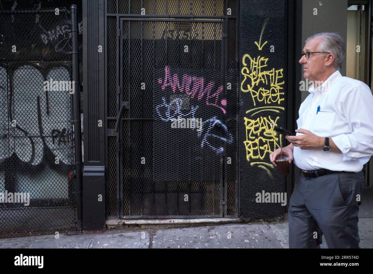 Seattle, USA. 8 Aug, 2023. A person passing graffiti in downtown Stock ...