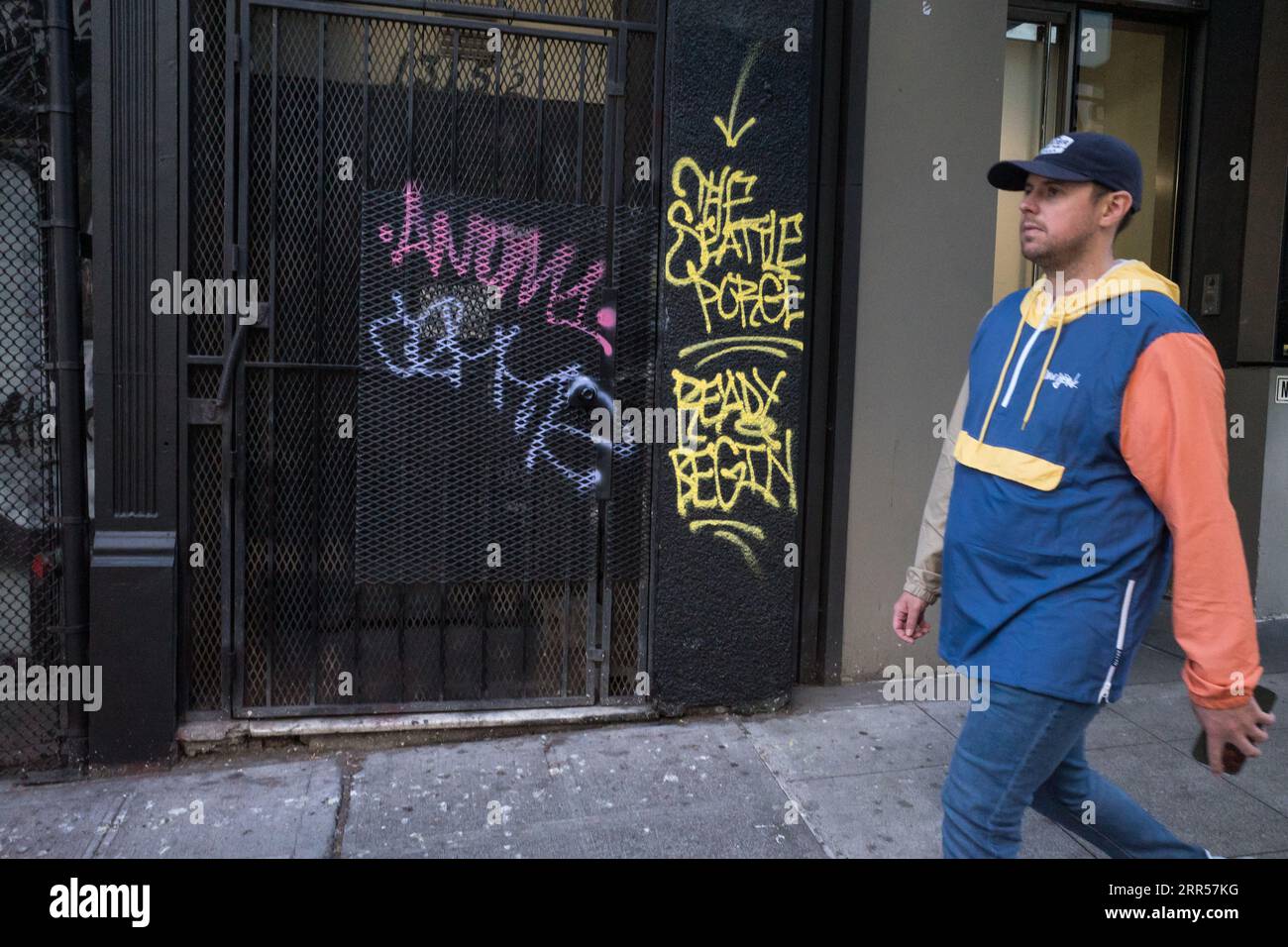 Seattle, USA. 8 Aug, 2023. A person passing graffiti in downtown Stock ...