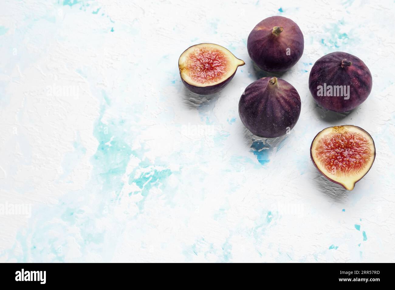 Fresh ripe figs on light blue background Stock Photo - Alamy