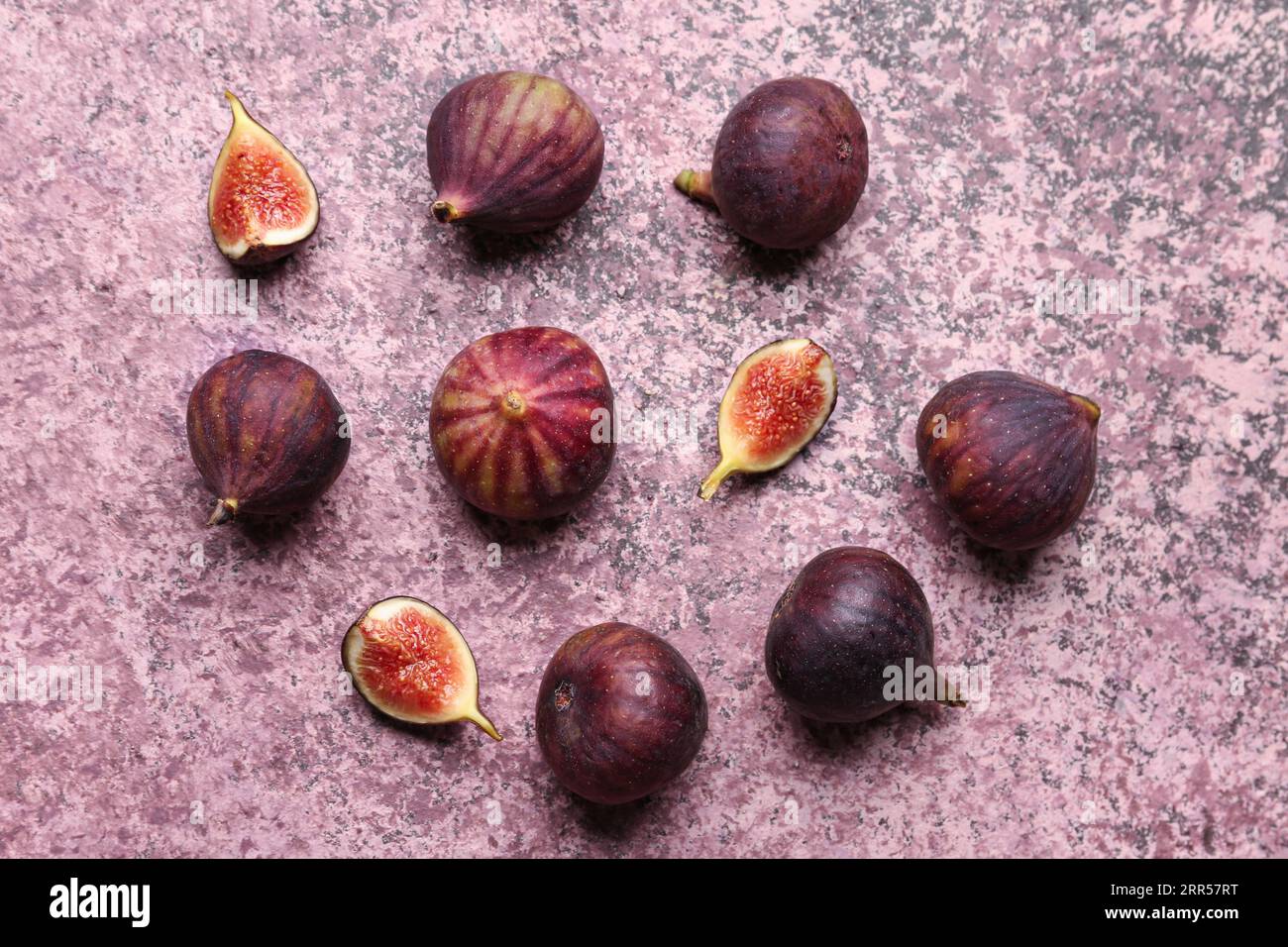 Fresh ripe figs on purple background Stock Photo - Alamy