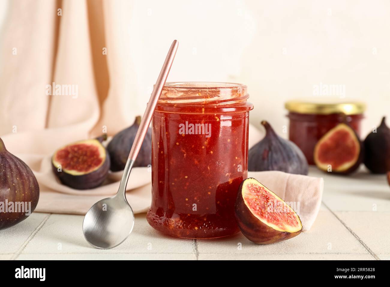 Jar of sweet fig jam on white tile table Stock Photo - Alamy