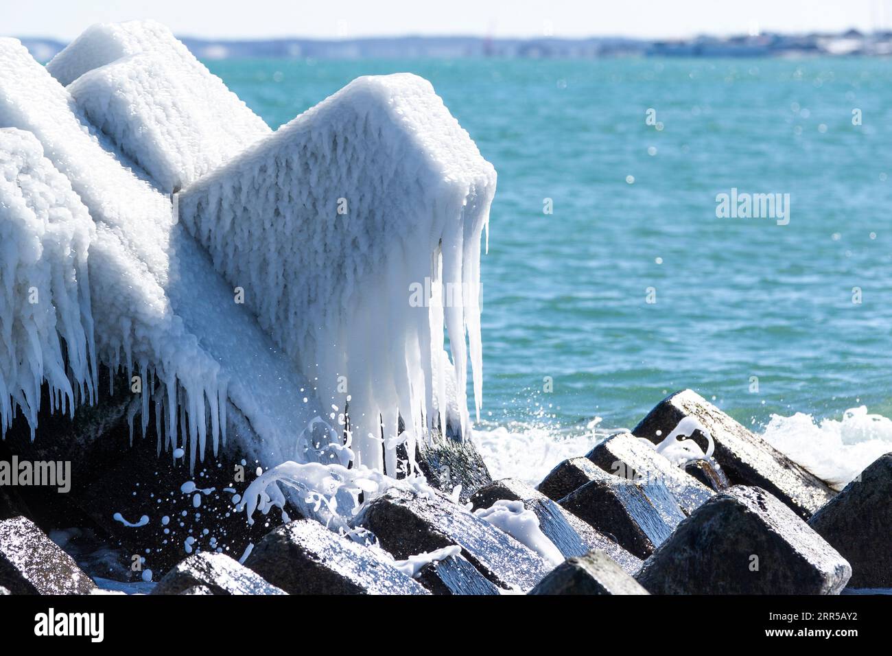 Ice covered concrete blocks as waves breakers on the Japanese beach in ...