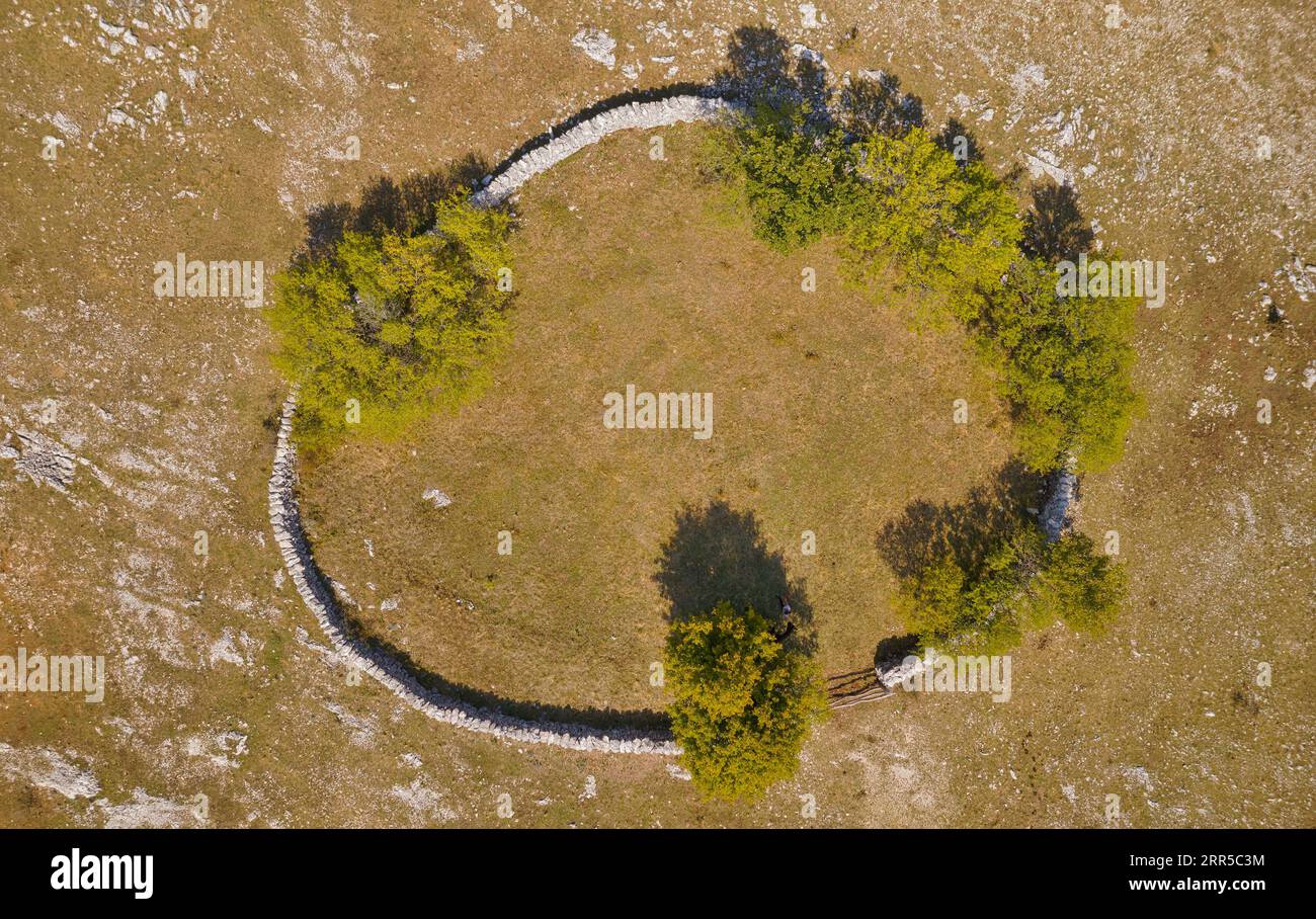 Aerial view of a circular dry stone wall enclosure historically used ...