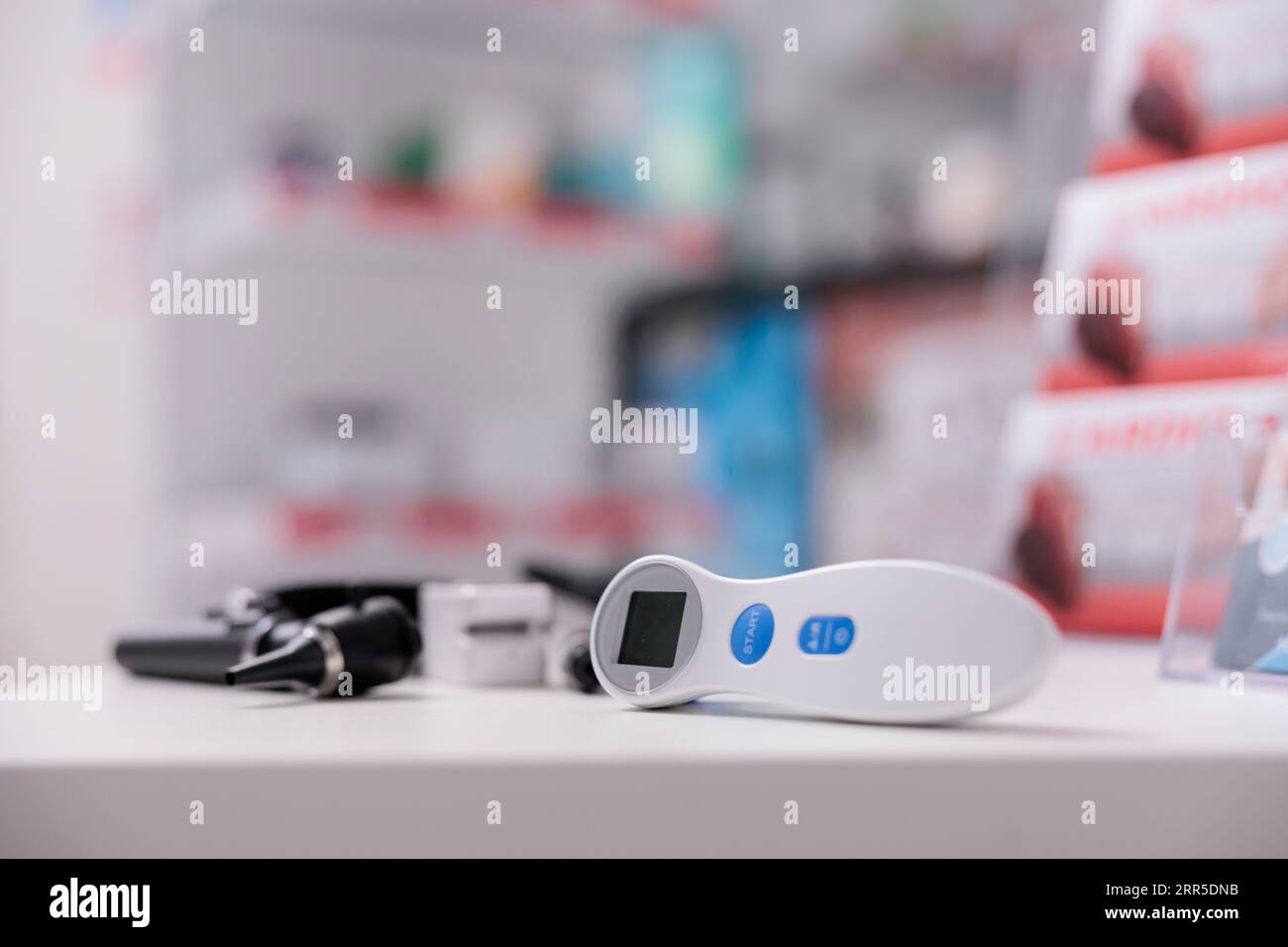 Medical thermometer standing on table in empty drugstore, health care ...