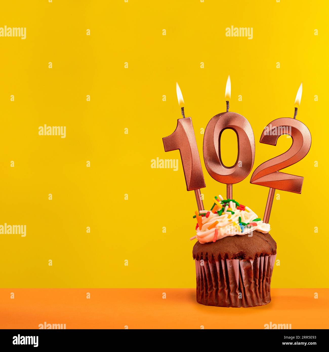 Number 102 birthday candle - Celebration on yellow background Stock ...