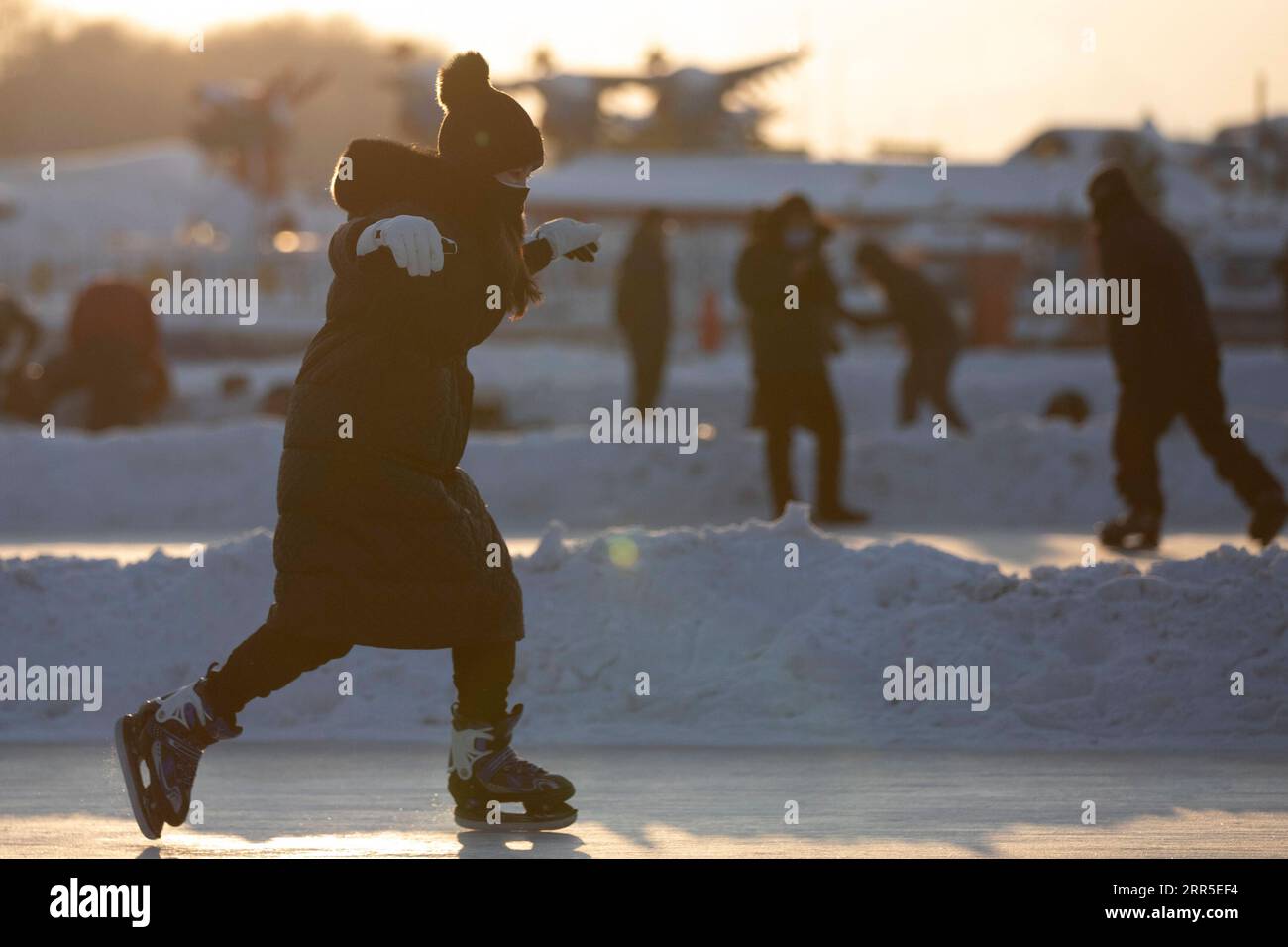 210103 -- HARBIN, Jan. 3, 2021 -- People skate on ice near Jiuzhan Park ...