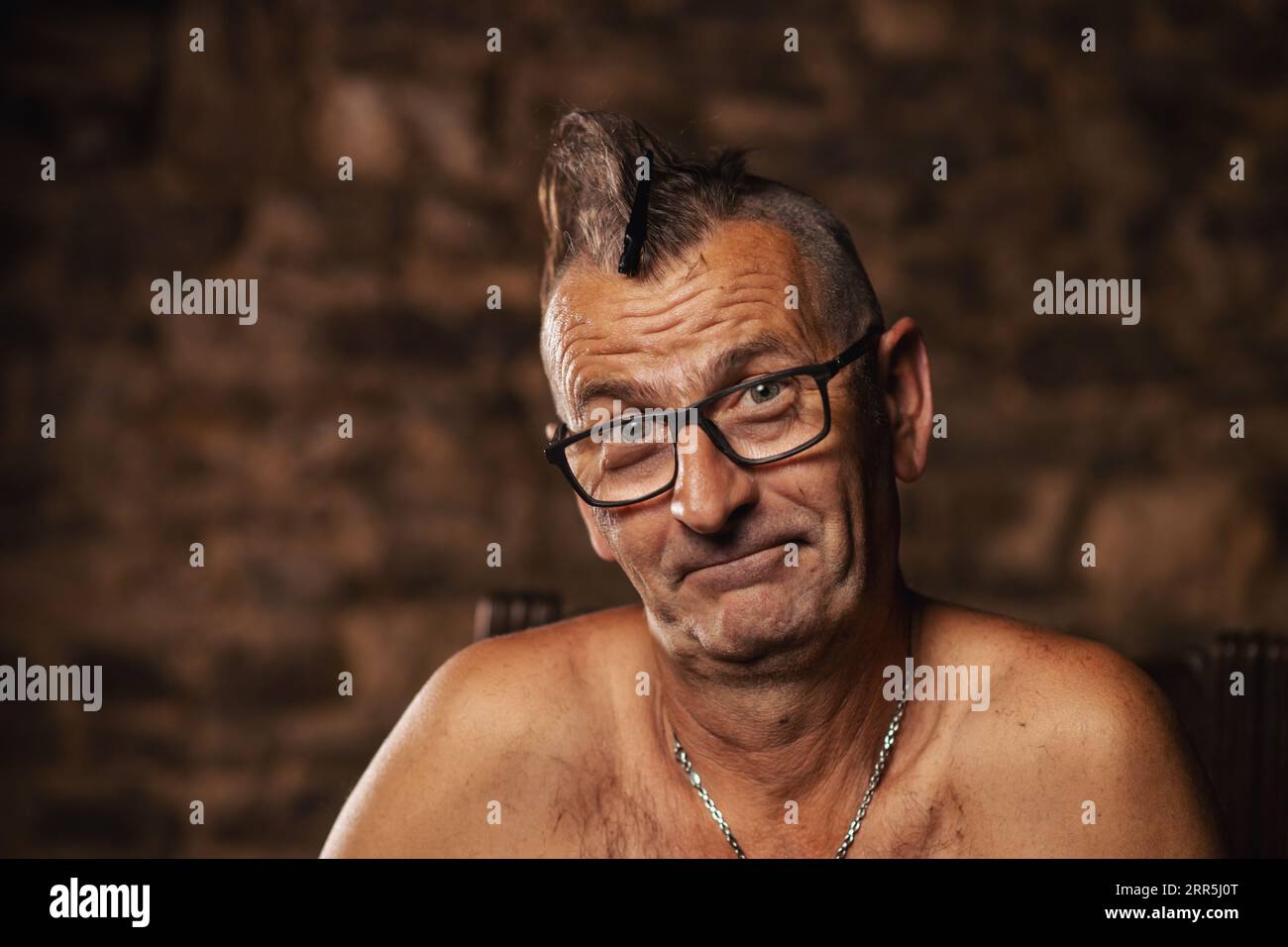 An older man, a pensioner, wearing glasses with a mohawk. Serbian ...