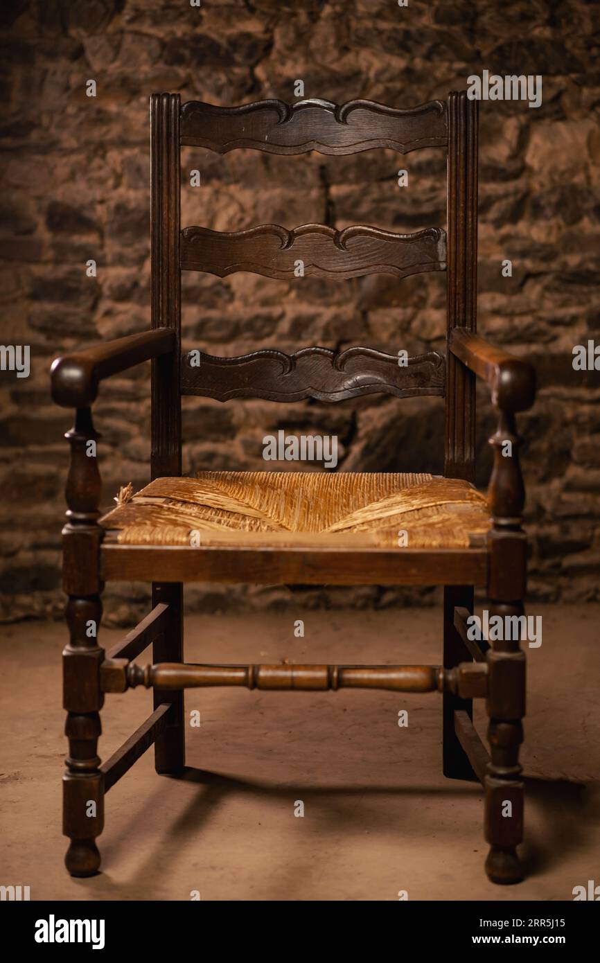 Empty antique chair on the background of a stone wall Stock Photo - Alamy