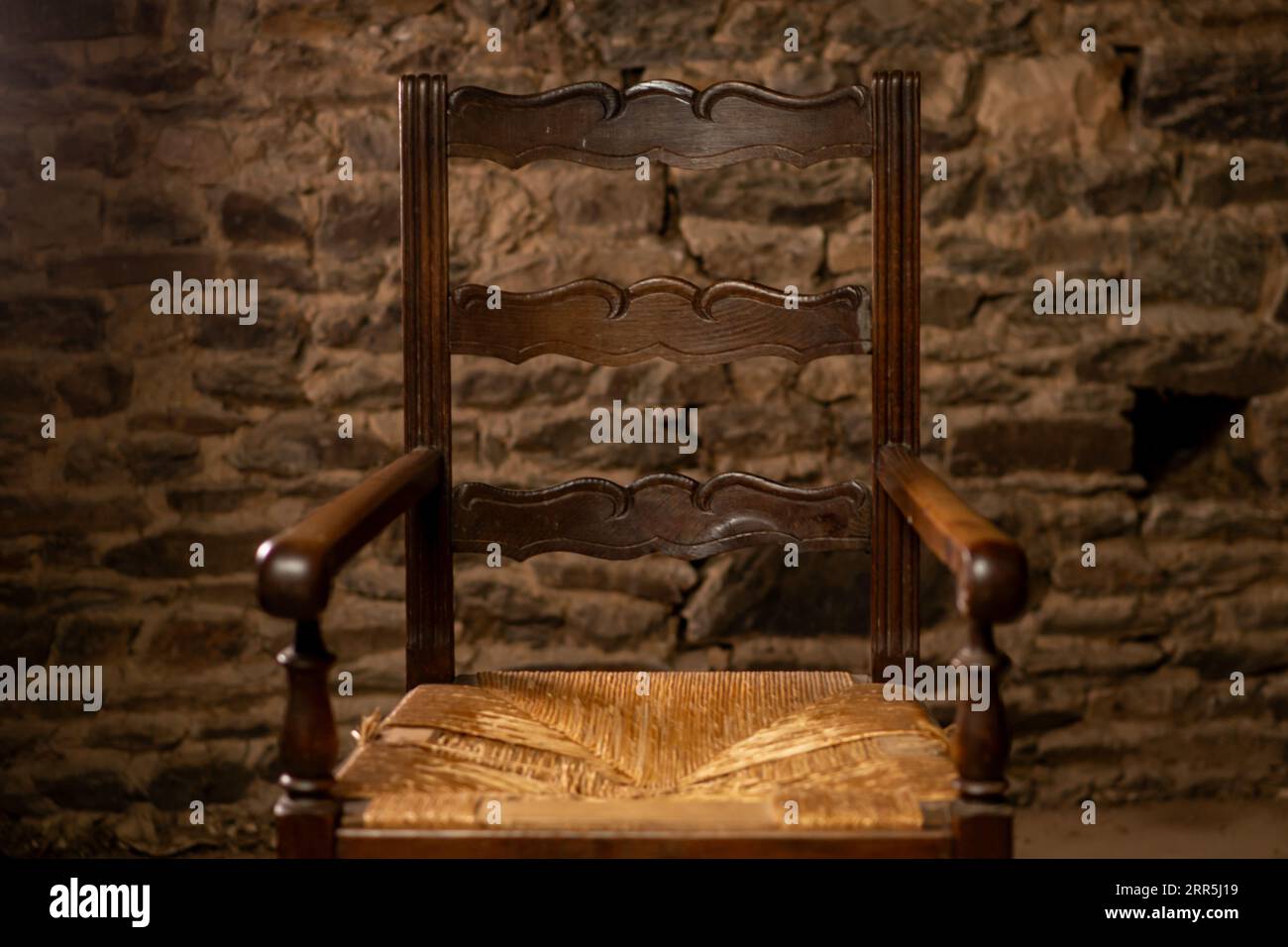 Empty antique chair on the background of a stone wall Stock Photo - Alamy