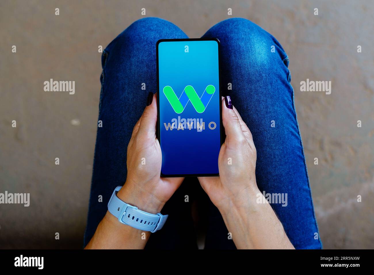 In this photo illustration, the Waymo logo is displayed on a smartphone ...