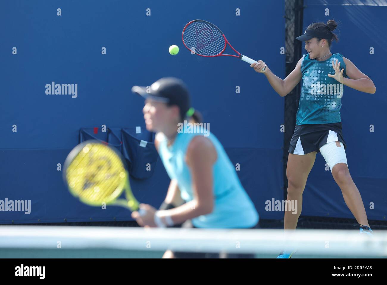 Ena Koike and Sayaka Ishii in action during a junior girls' doubles ...