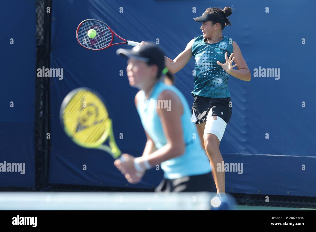 Ena Koike and Sayaka Ishii in action during a junior girls' doubles ...
