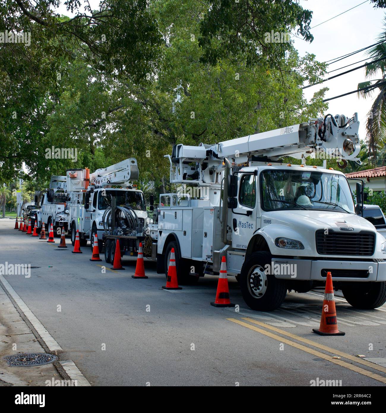 MasTec power line trucks repairing the street in Miami Florida Stock ...