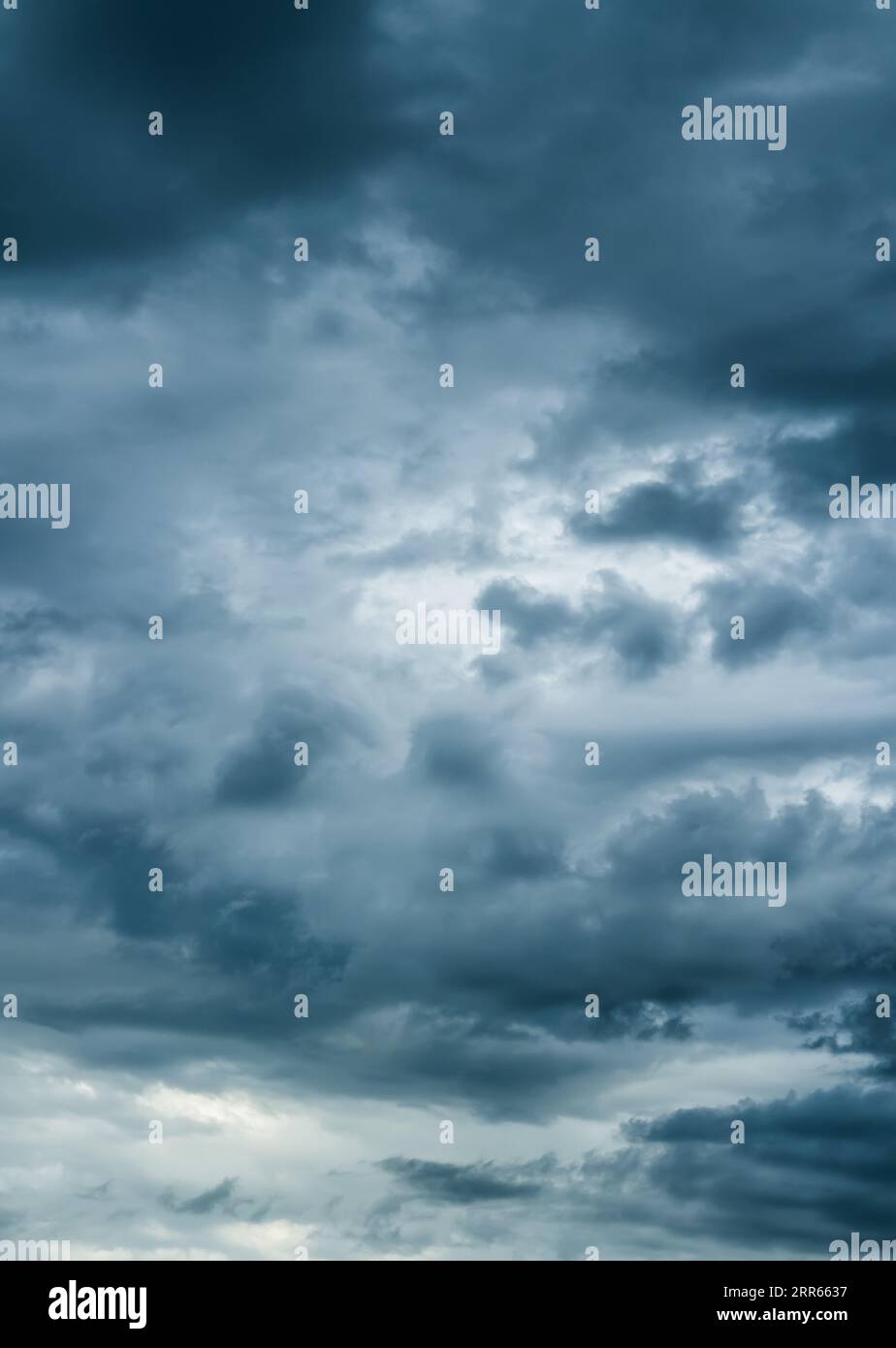 The dark sky with heavy clouds converging and a violent storm before ...