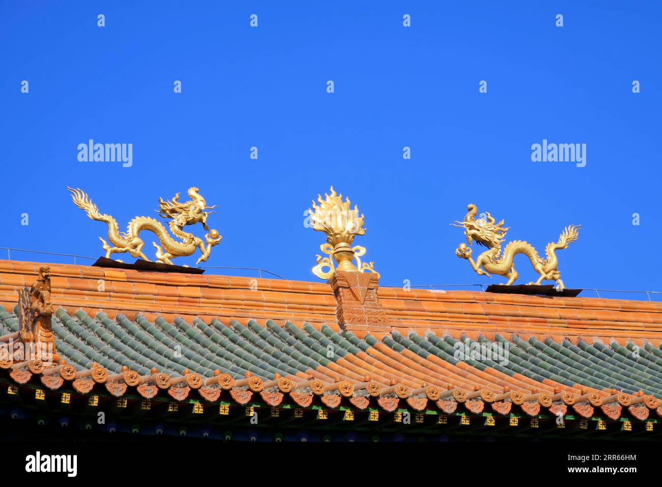 Glazed tile roof and Gilding copper Dharma chakra in a temple, closeup ...