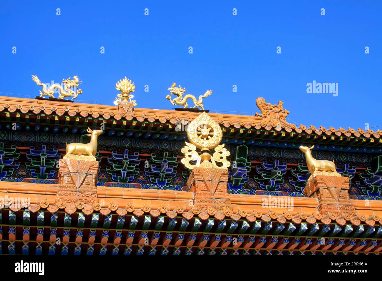Glazed tile roof and Gilding copper Dharma chakra in a temple, closeup ...