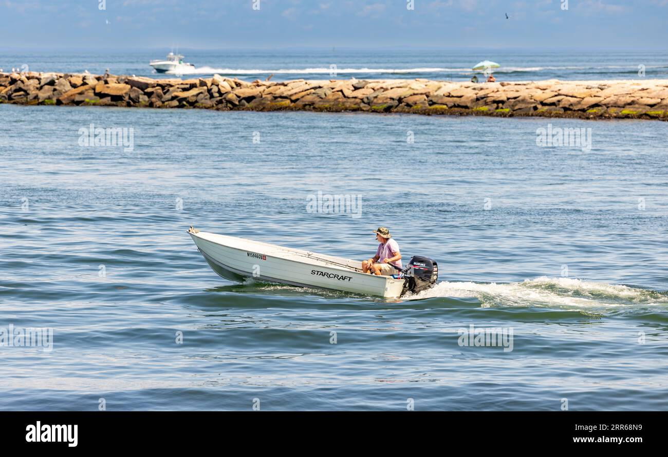 small dingy headed out of montauk Stock Photo - Alamy