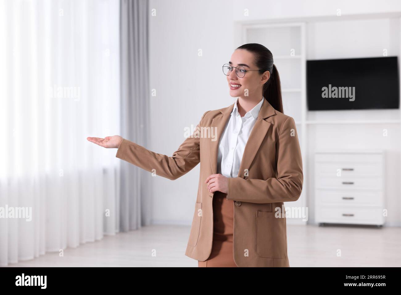 Happy real estate agent showing new apartment Stock Photo - Alamy