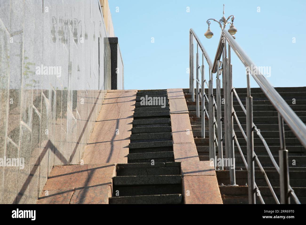 Staircase and ramp with metal handrail near building outdoors Stock ...